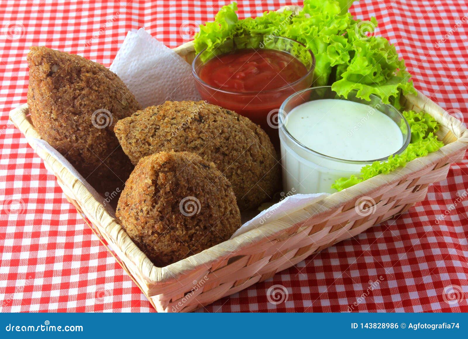 Fried Kibbeh with Tomato Sauce in a Basket, Over Rustic Wooden Table ...