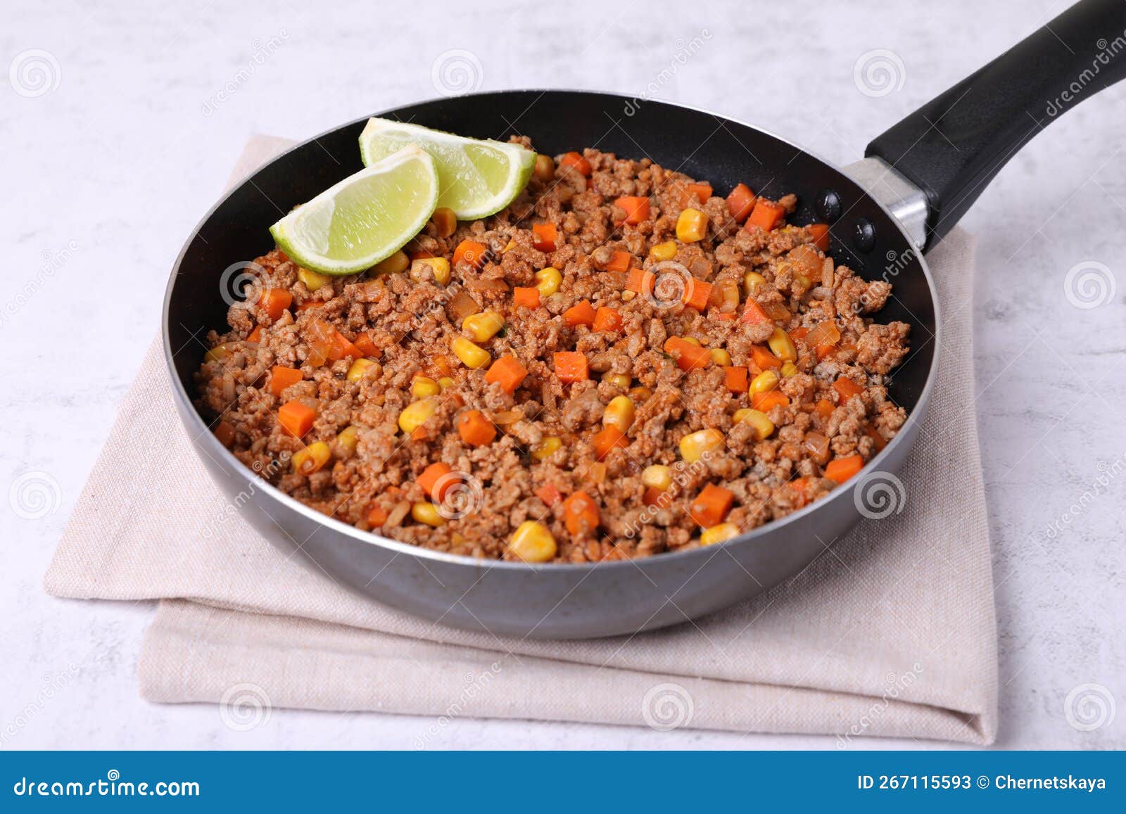 Fried Minced Meat, Carrot, Corn and Lime in Pan on White Textured Table ...