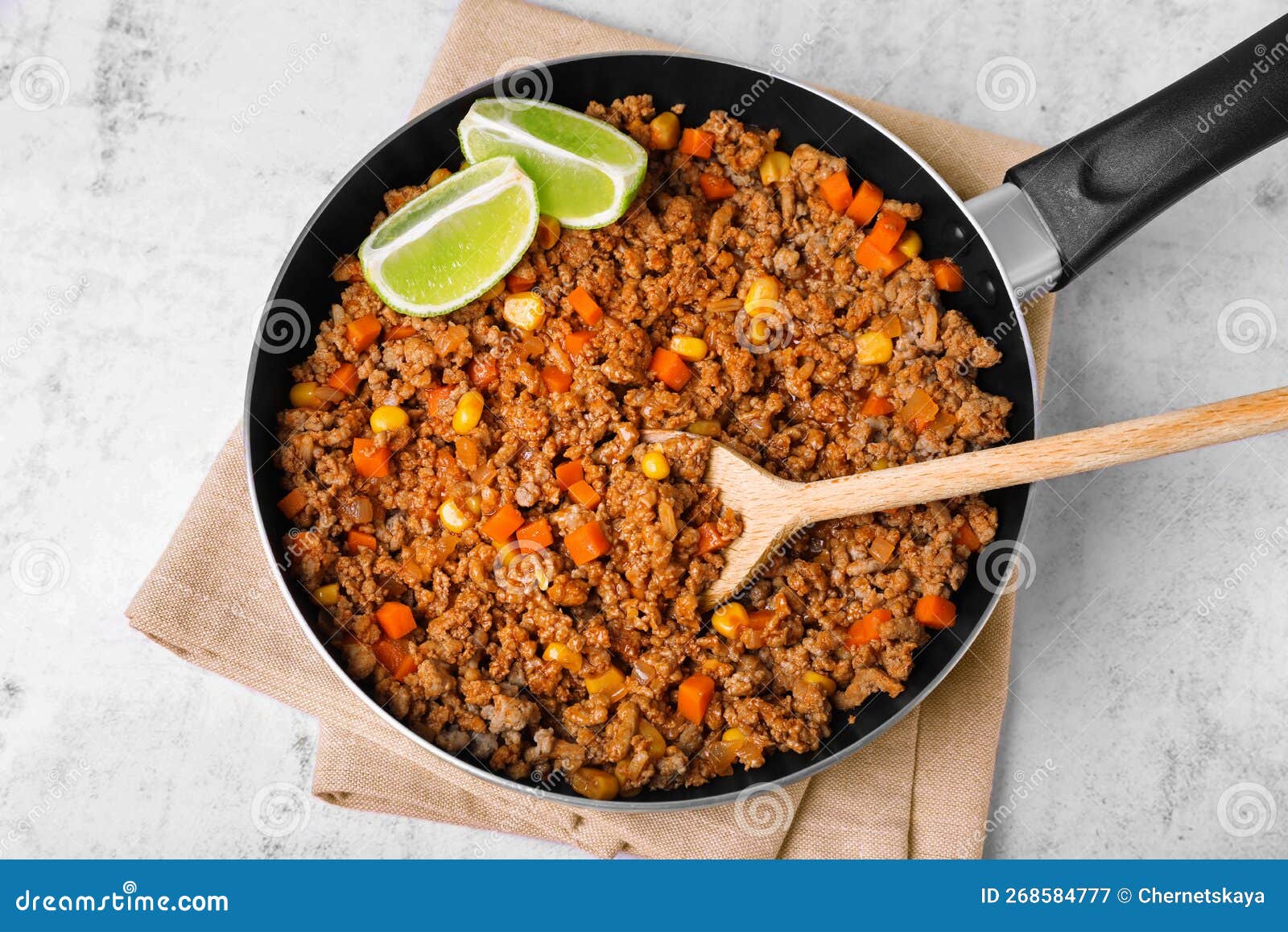 Fried Minced Meat, Carrot, Corn and Lime in Pan on White Textured Table ...