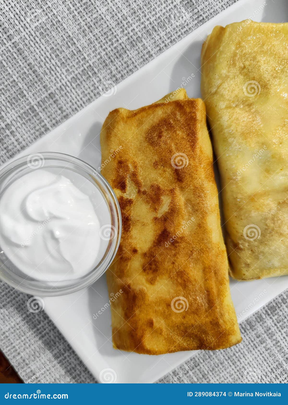 Fried Pancakes Stuffed with Meat and Sour Cream on a Rectangular White ...