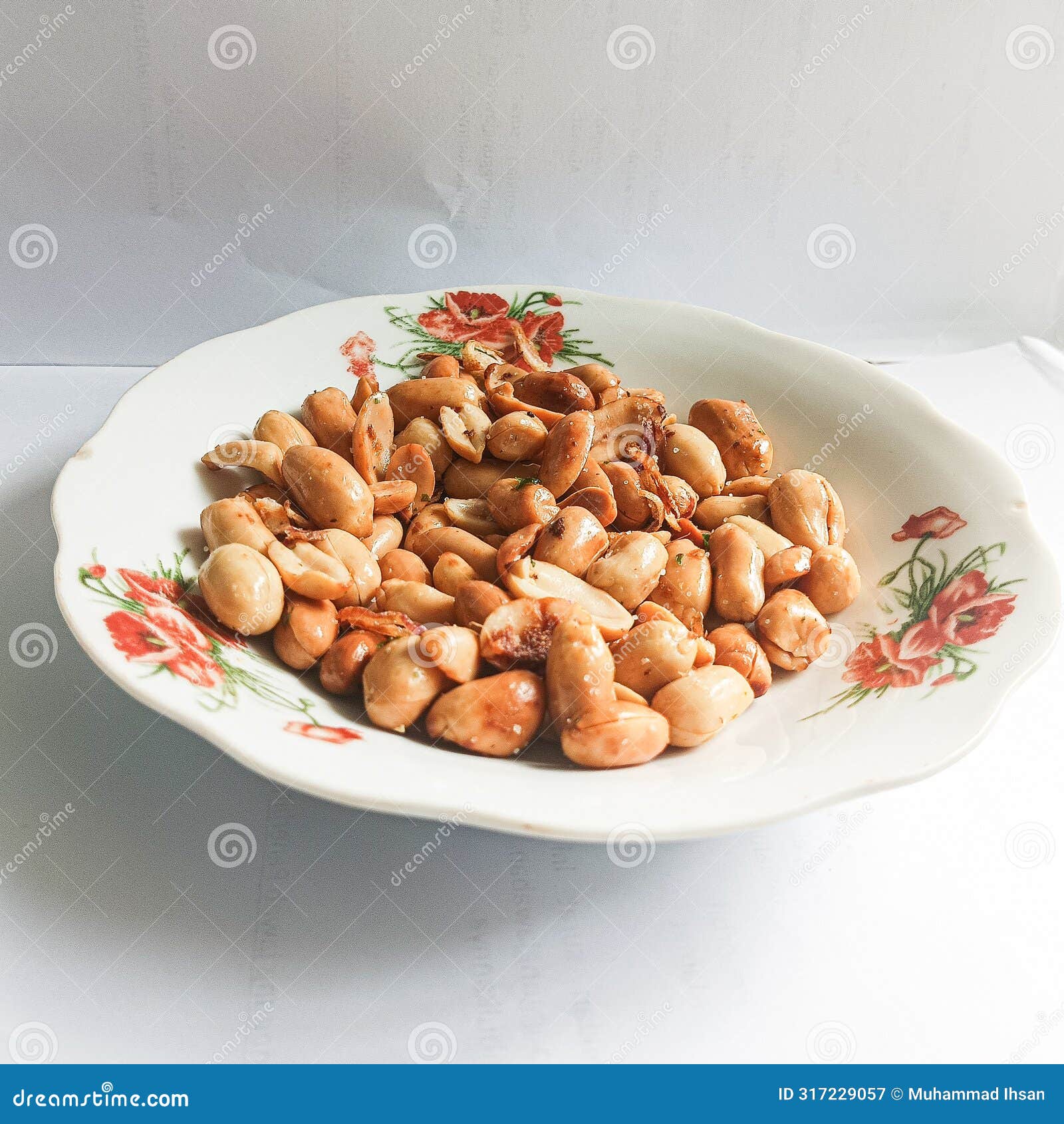 Fried Peanuts are Placed on a Small Plate with Floral Motifs Stock ...
