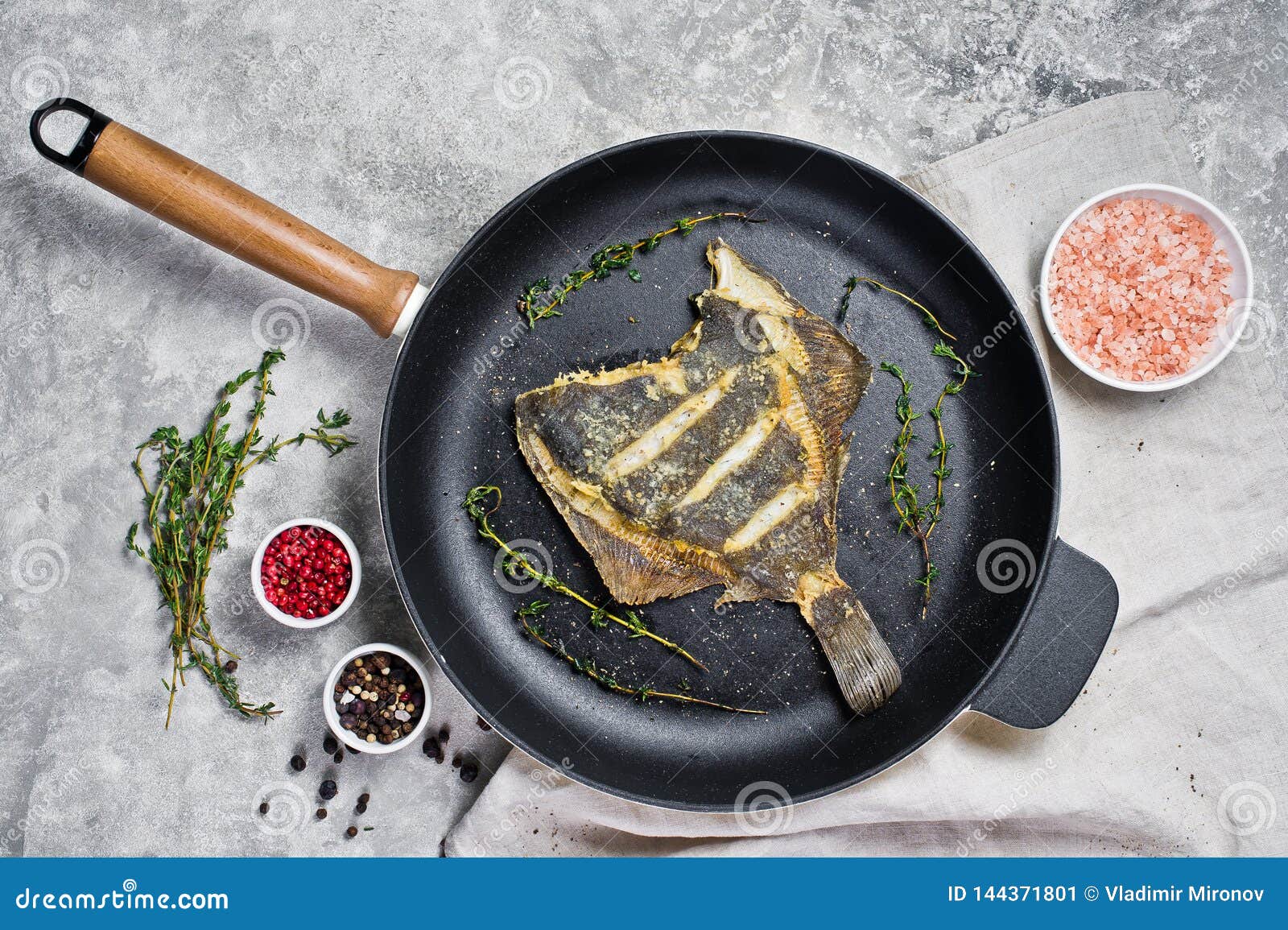 Fried Plaice Fillet With Herb Butter And Lemon On A Plate On A Wooden ...