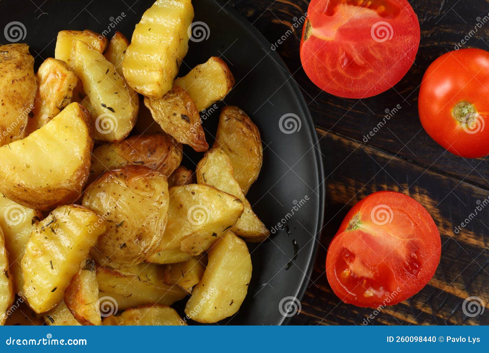 Fried Potatoes in a Black Plate. Homemade Fried Potatoes with Tomatoes ...