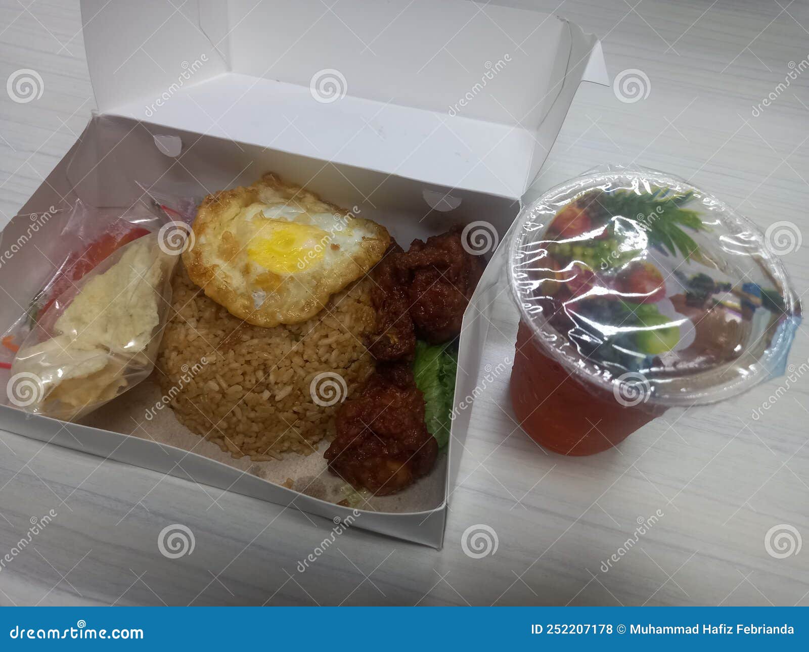 Fried Rice Box with Egg and Chicken, with Some Crackers and Pickles As ...
