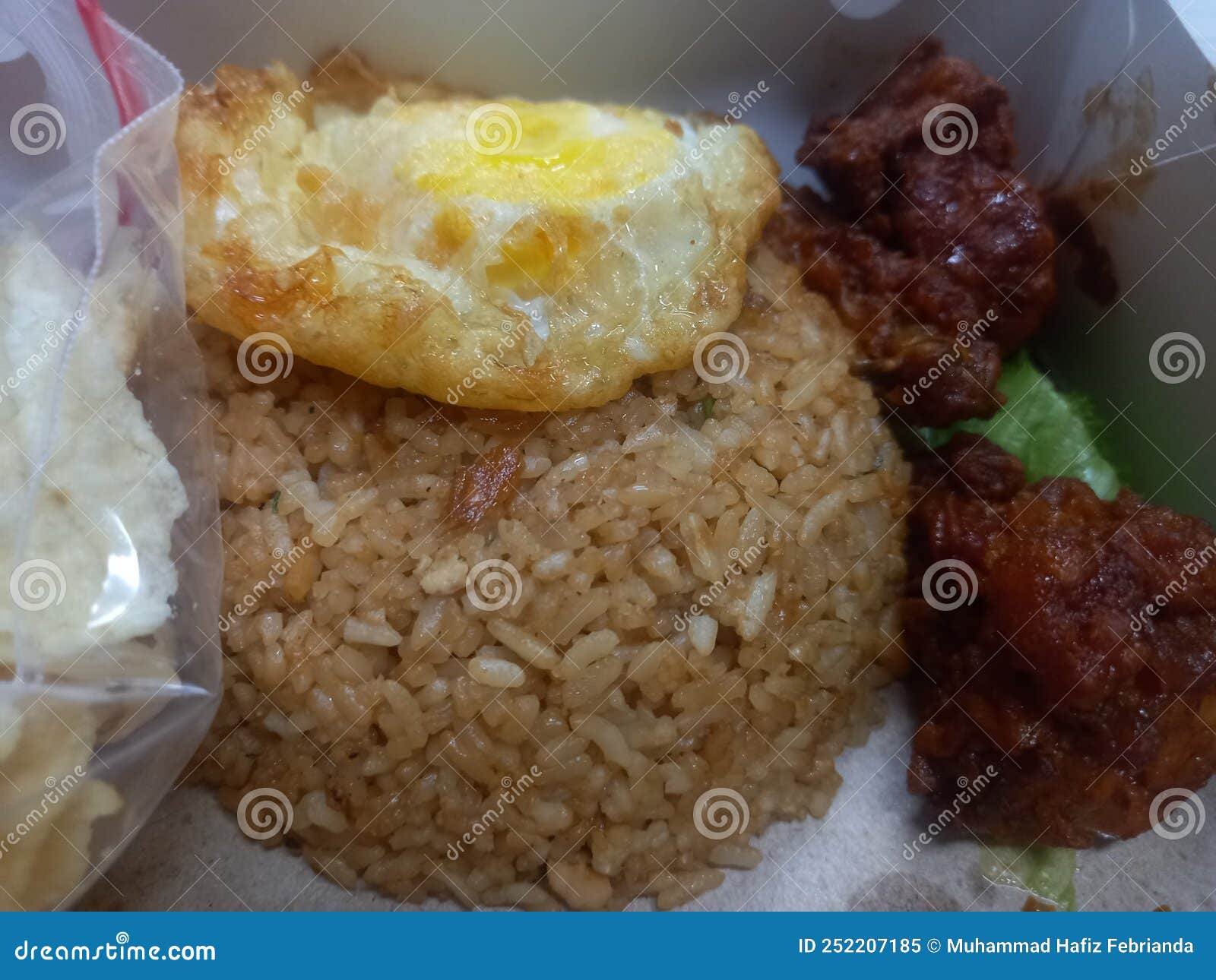 Fried Rice Box with Egg and Chicken, with Some Crackers and Pickles To ...