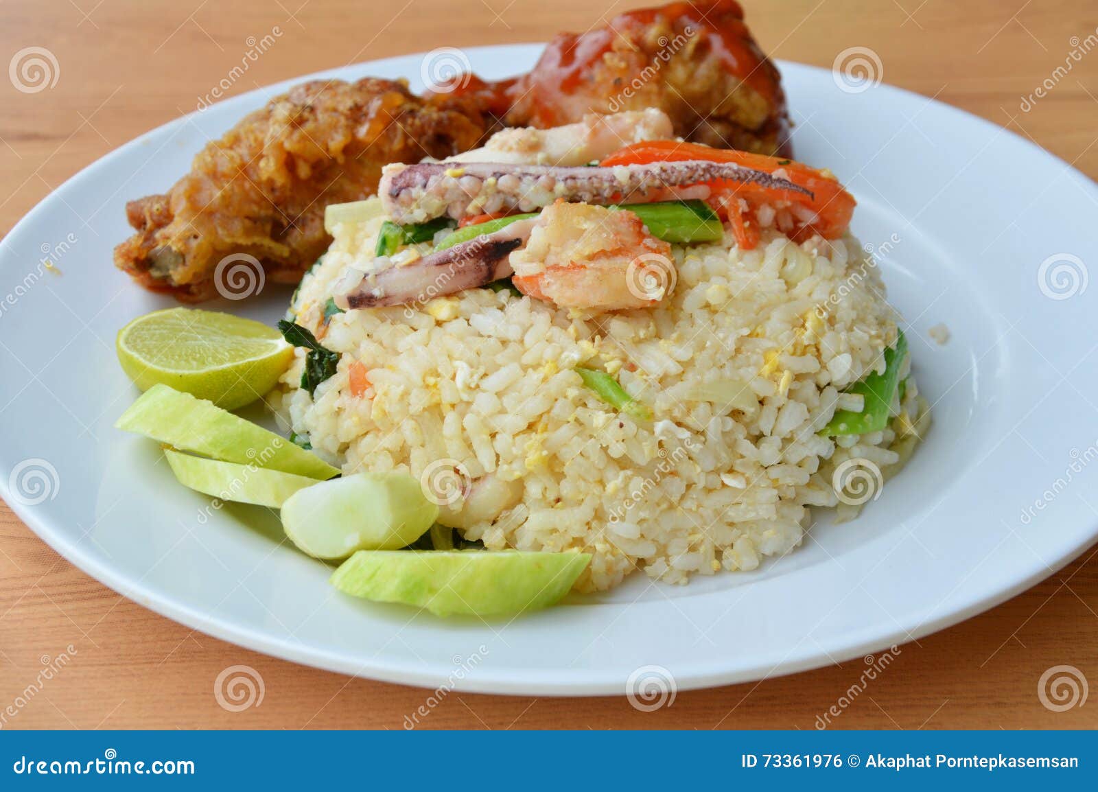 Fried Rice with Mixed Seafood and Crispy Chicken on Plate Stock Photo ...