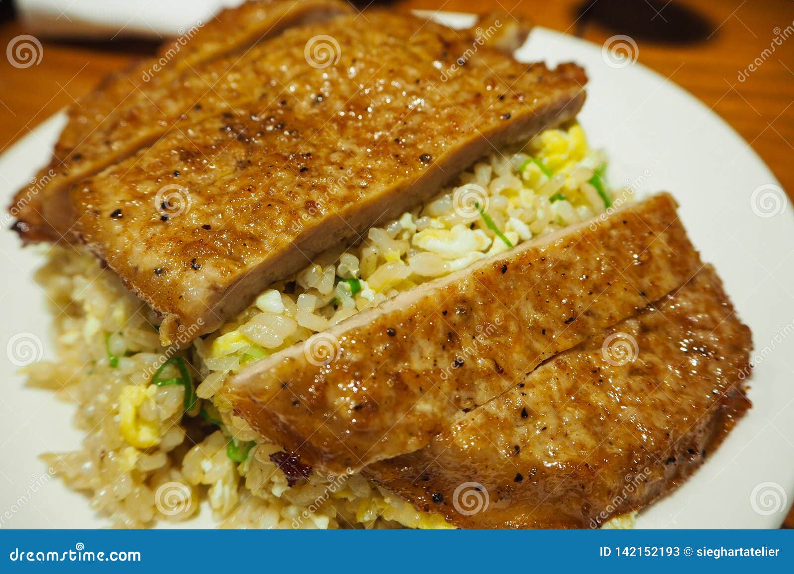 Fried rice with pork chop stock image. Image of delicious - 142152193