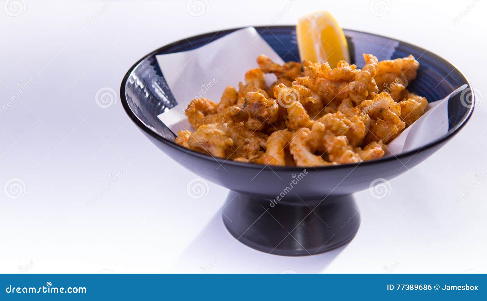 Fried Ring Octopus with Lemon in Blue Chinese Bowl on White Back Stock ...