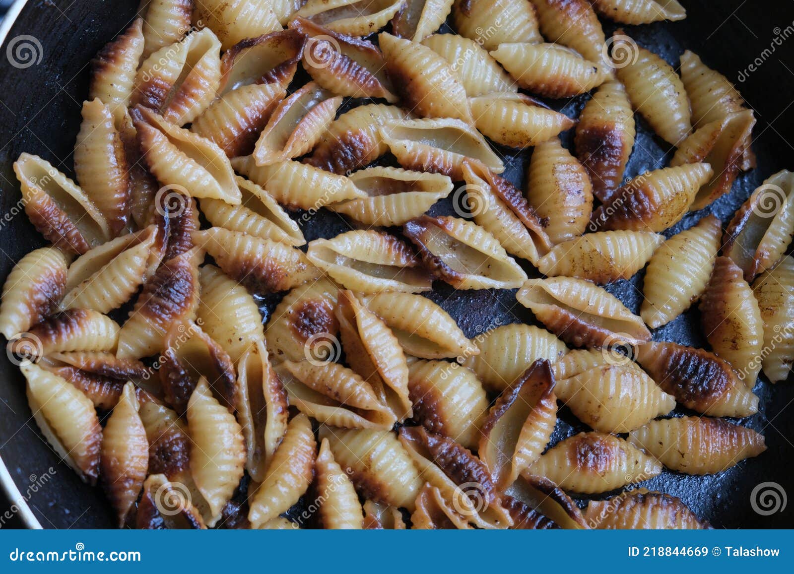 Fried shell pasta in a pan stock image. Image of pasta - 218844669
