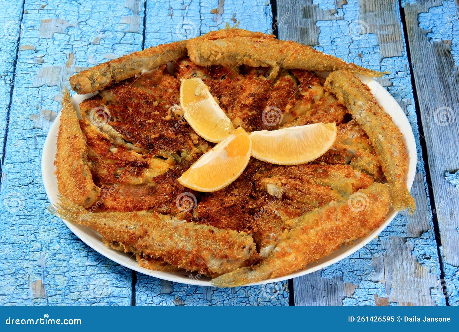 Fried Small Fish on a Plate, Decorated with Lemon Slices Stock Image ...
