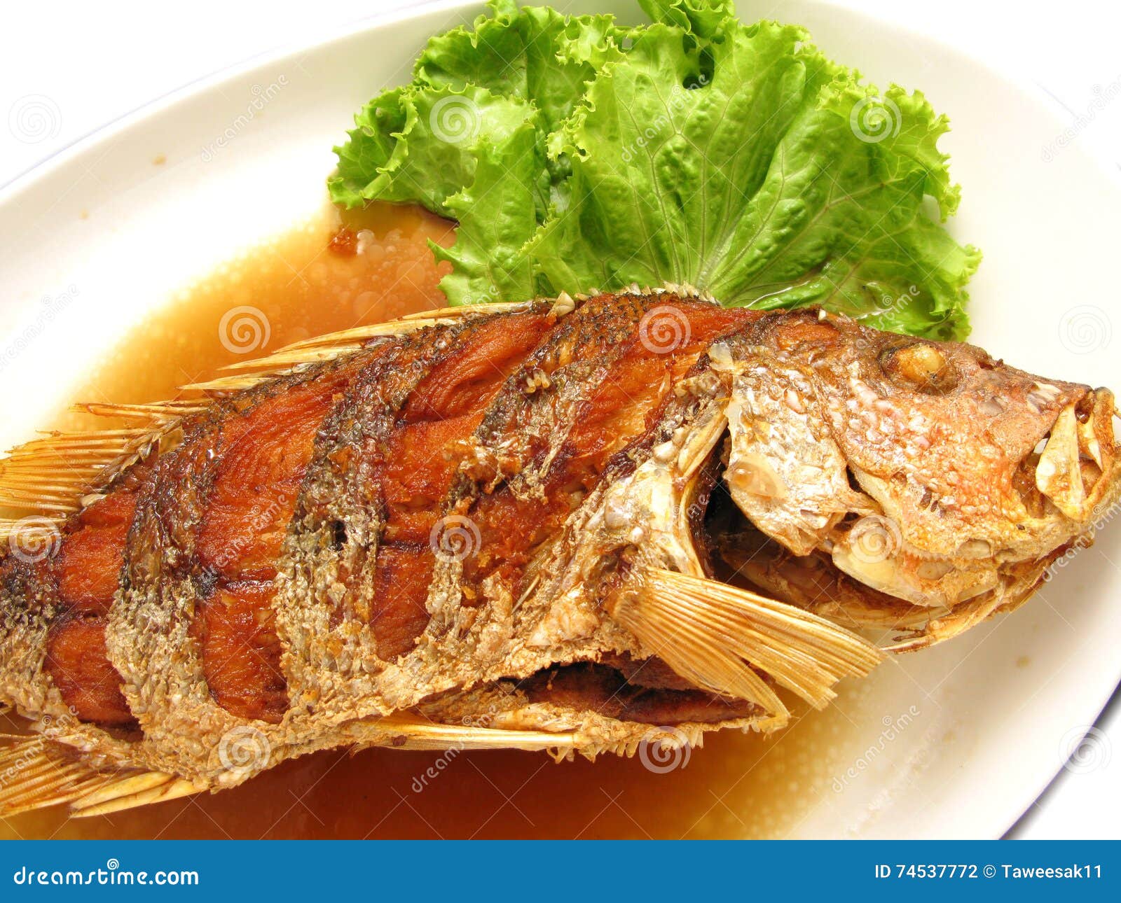 Fried Snapper with Fish Sauce on the Dish Stock Photo - Image of ...