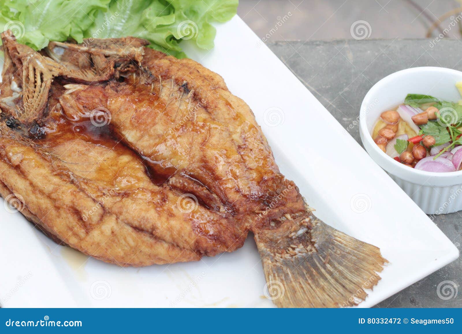 Fried Snapper with Fish Sauce and Spicy Salad. Stock Photo - Image of ...