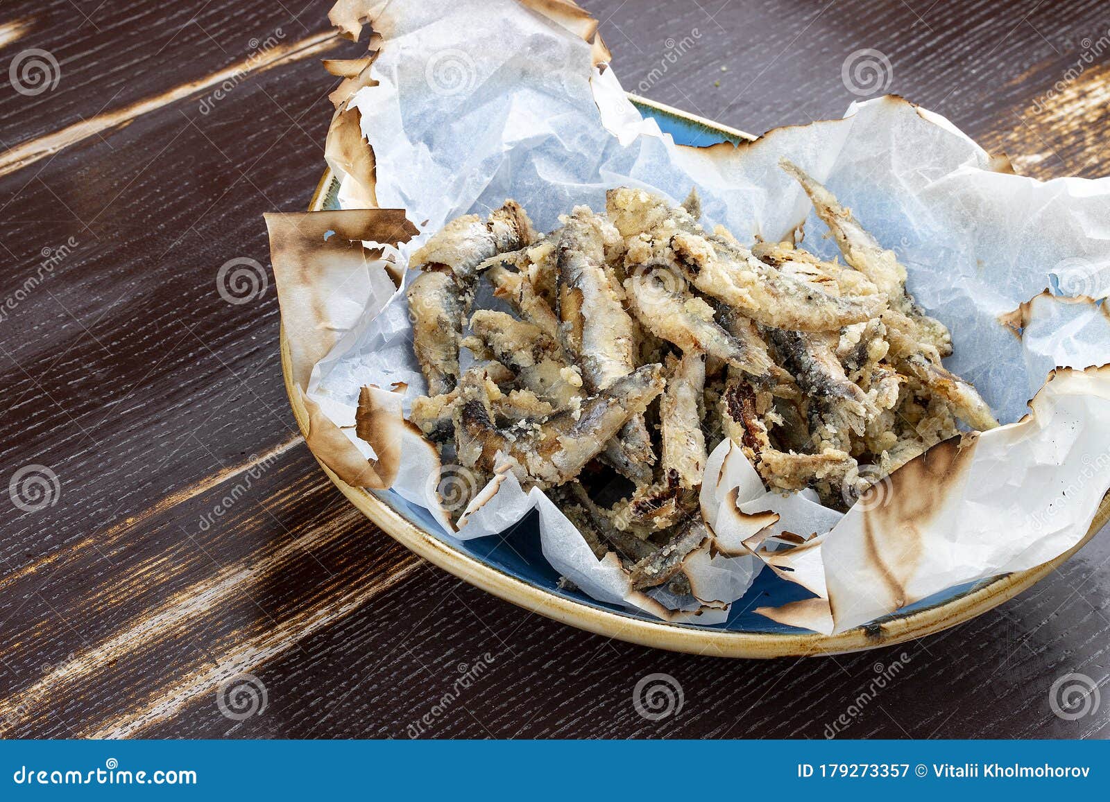 Fried Sprat in Parchment on Wooden Background Stock Image - Image of ...