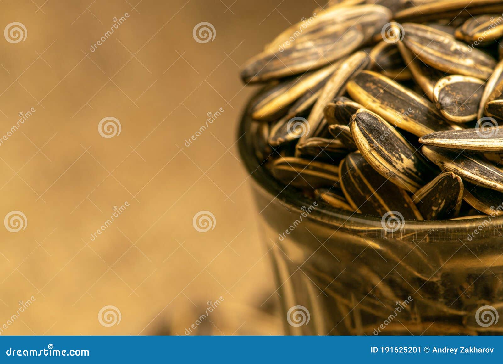 Fried Sunflower Seeds in a Glass Cup and Sunflower Seeds Scattered on ...