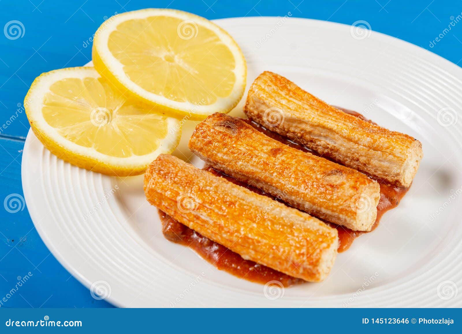 Fried Surimi Sticks with Lemons on the Blue Wooden Boards Stock Photo ...