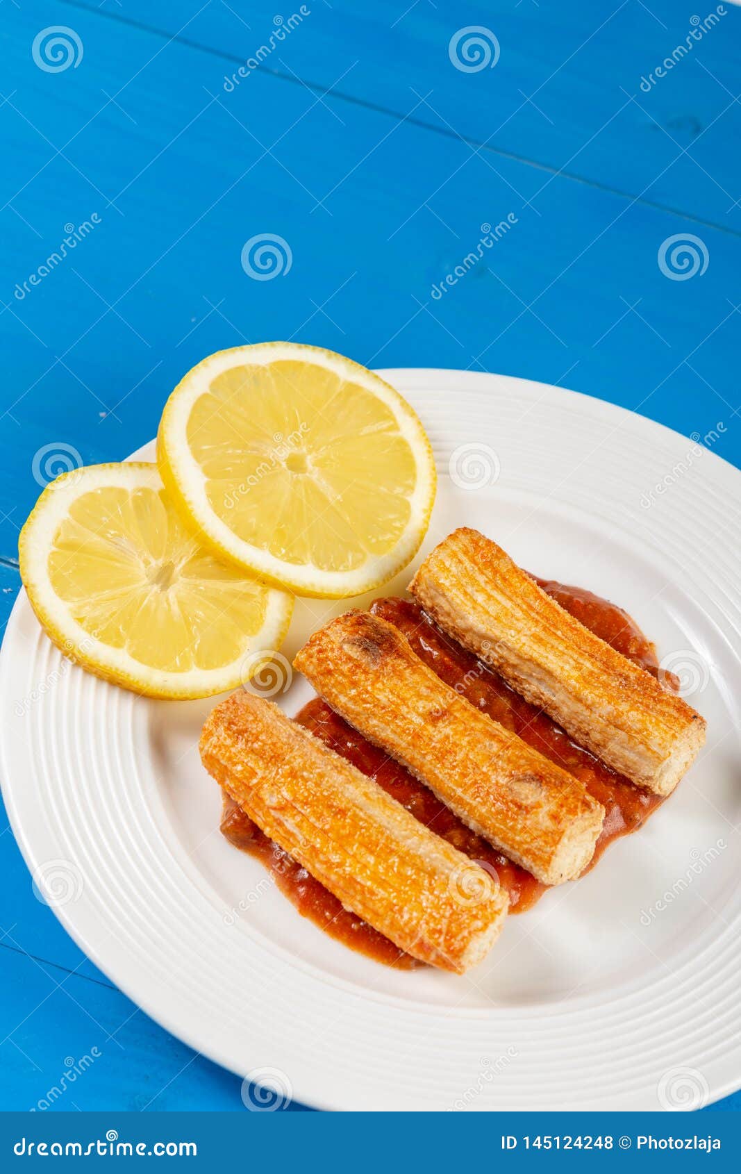 Fried Surimi Sticks with Lemons on the Blue Wooden Boards Stock Photo ...
