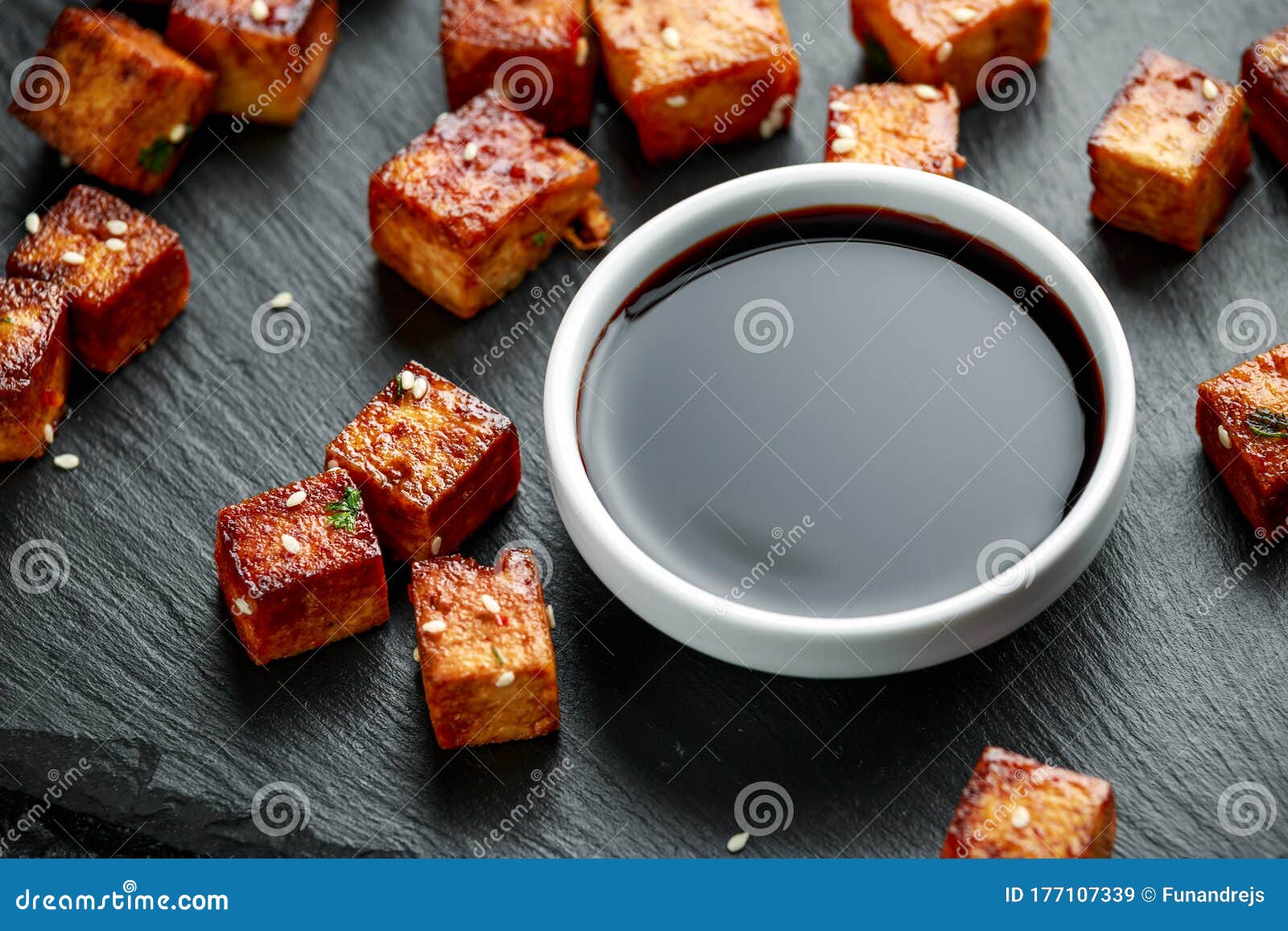 Fried Tofu with Chopstick and Sesame Seeds on Rustic Stone Board Stock ...