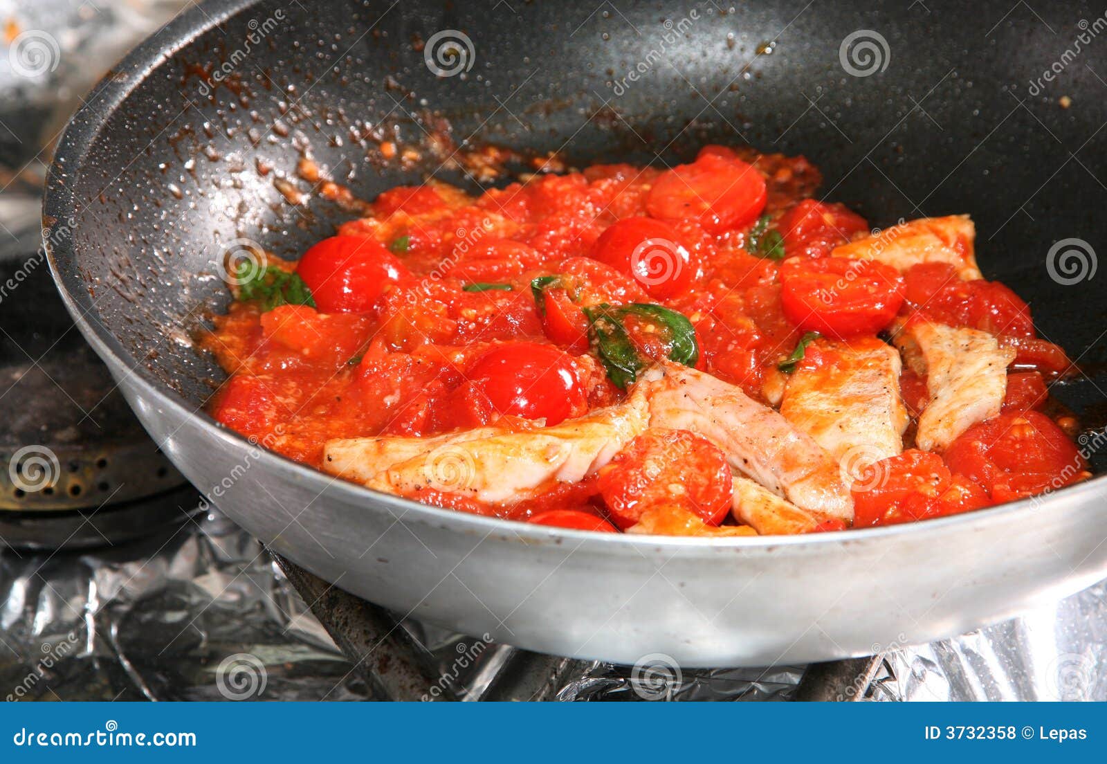 Fried tomato and fish stock photo. Image of metal, burner - 3732358