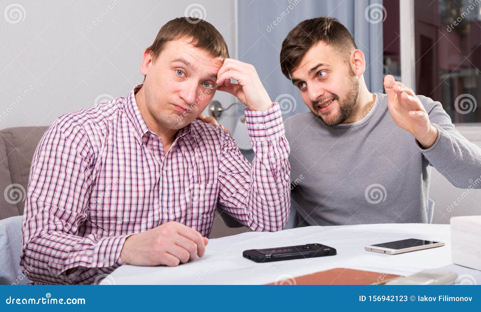 Friend Calming Distressed Guy at Home Table Stock Image - Image of ...