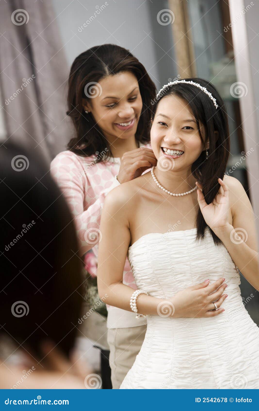 Friend helping bride. stock photo. Image of color, asian - 2542678