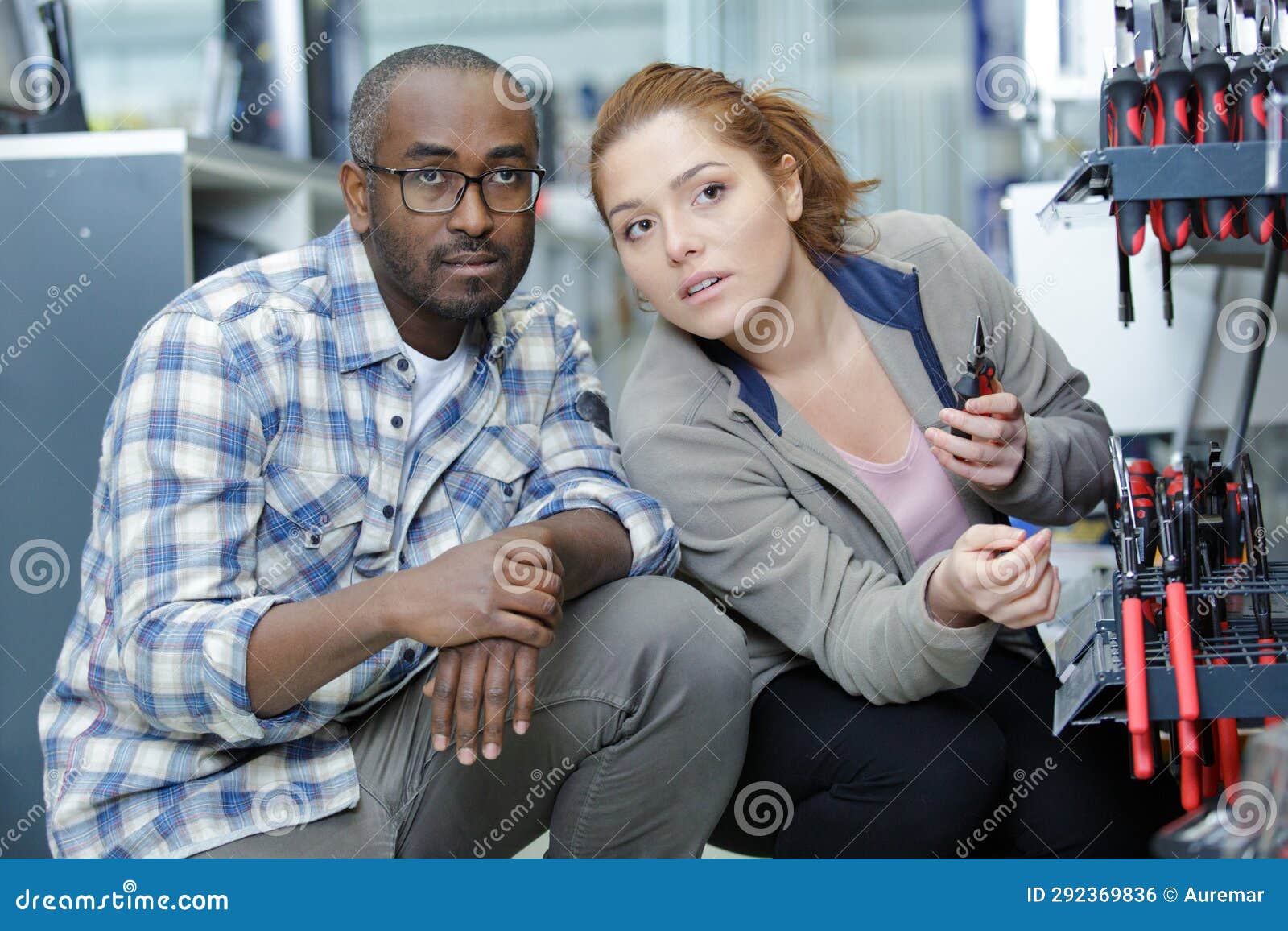 Friendly African Hardware Store Assistant Helping Young Couple Choosing ...