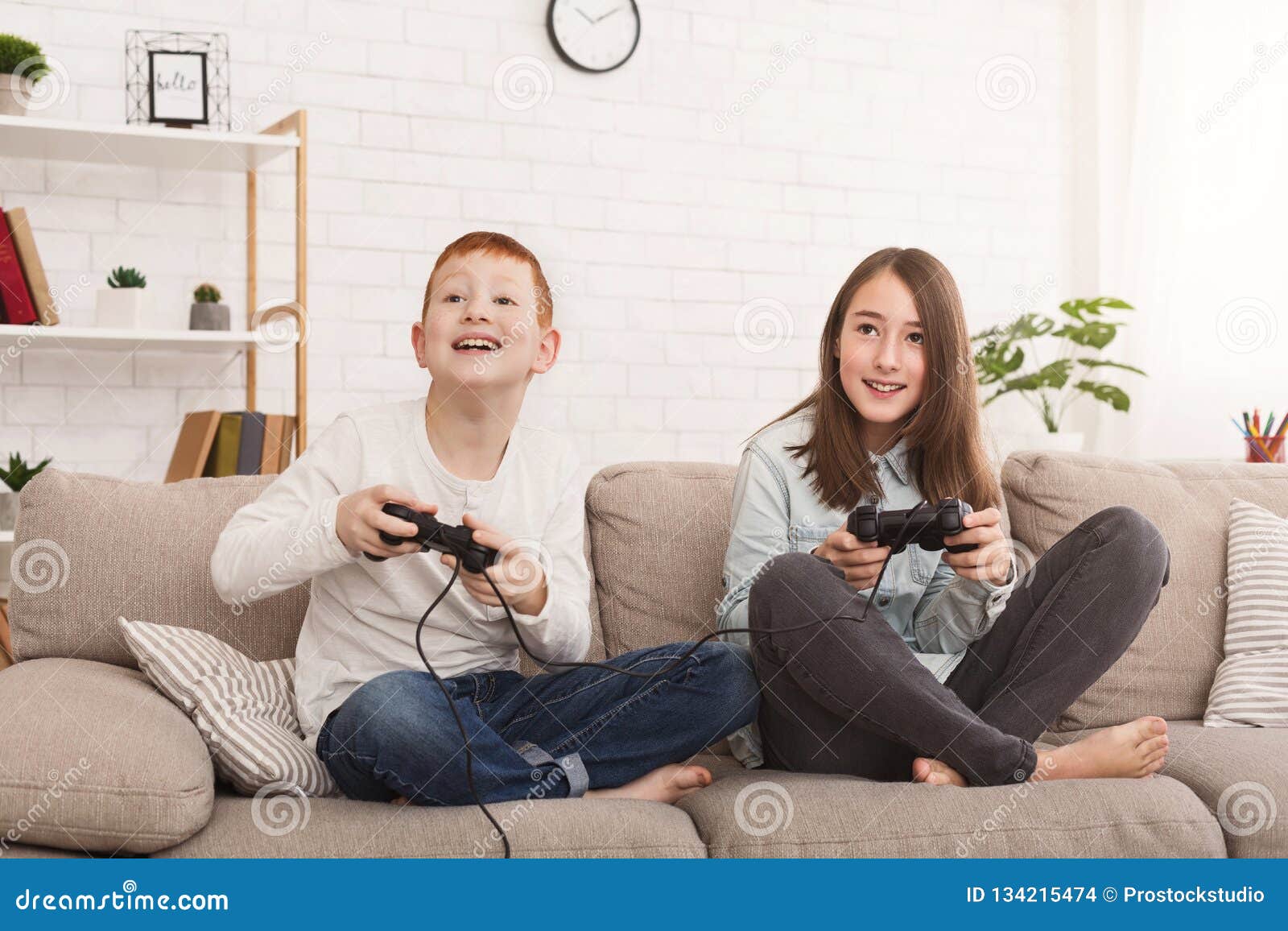 Friendly Brother and Sister Playing Video Games Together Stock Photo ... Friendly Brother and Sister Playing Video Games Together Stock Photo ...
