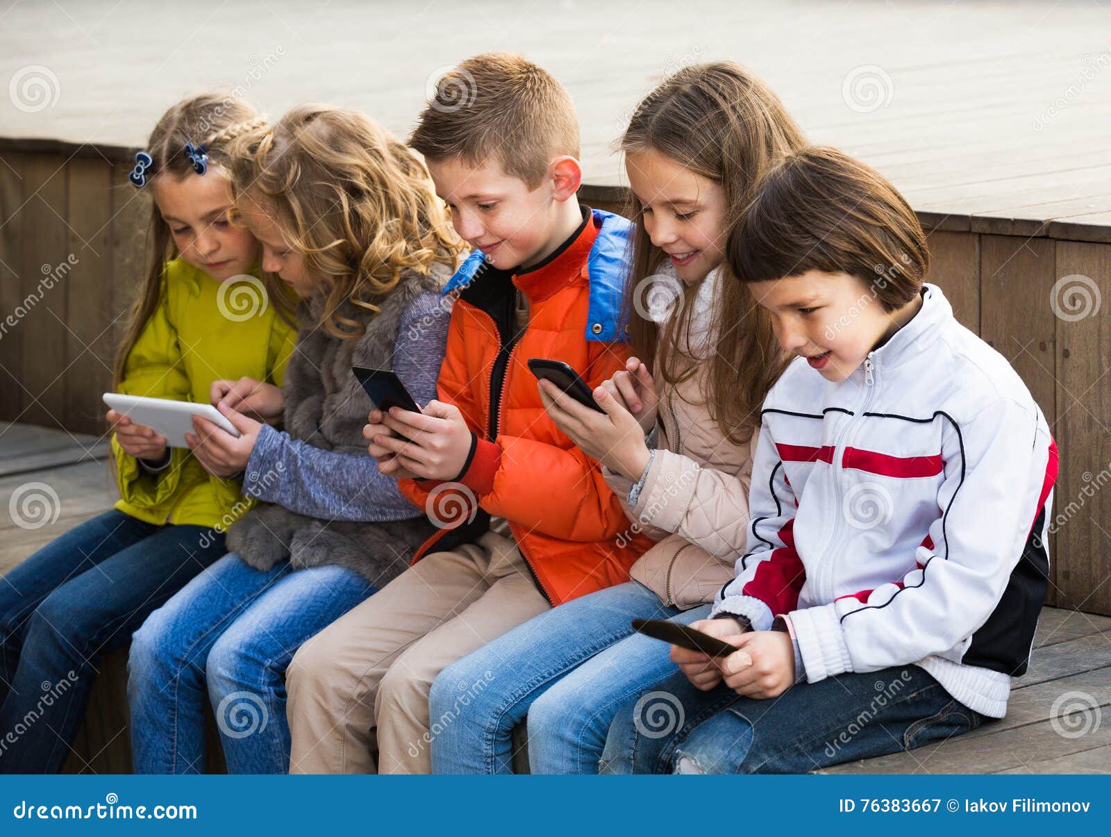 Friendly Children Sitting with Mobile Devices Stock Image - Image of ...
