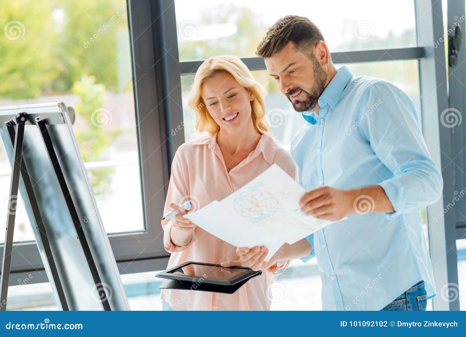 Friendly Colleagues Working Together at Their Project Stock Photo ...