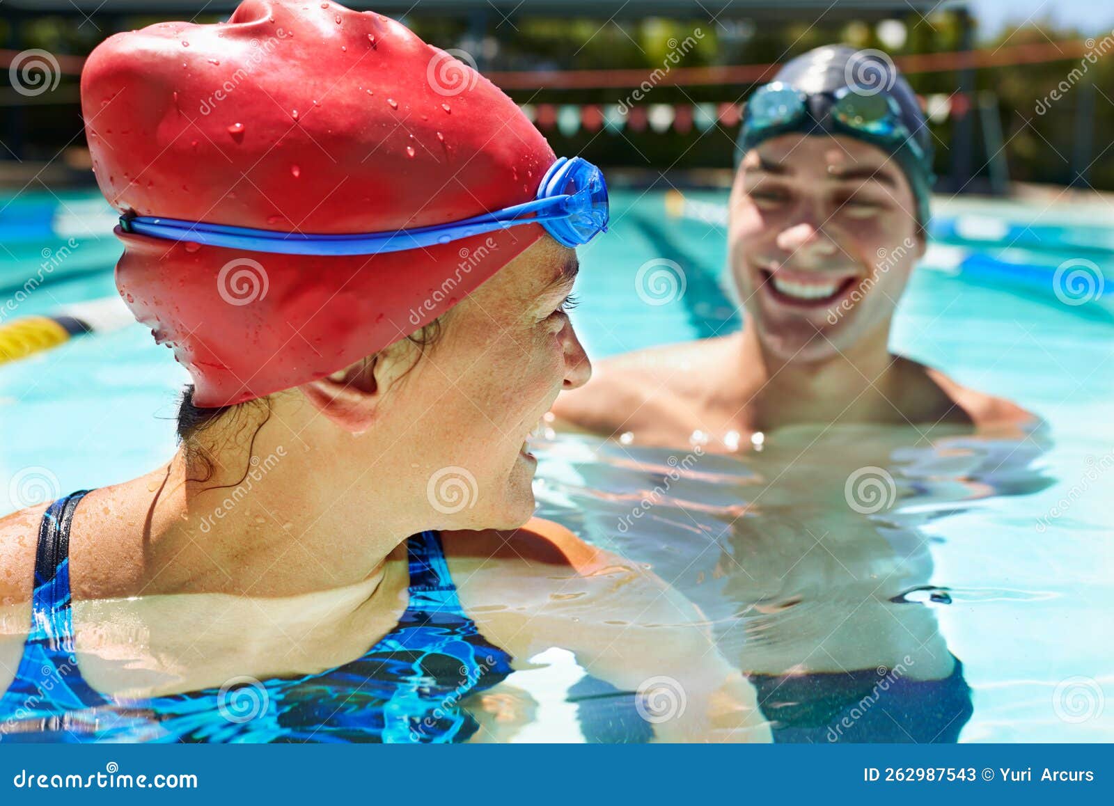 Friendly Competition. Two Swimmers Standing in a Pool Smiling at Each ...