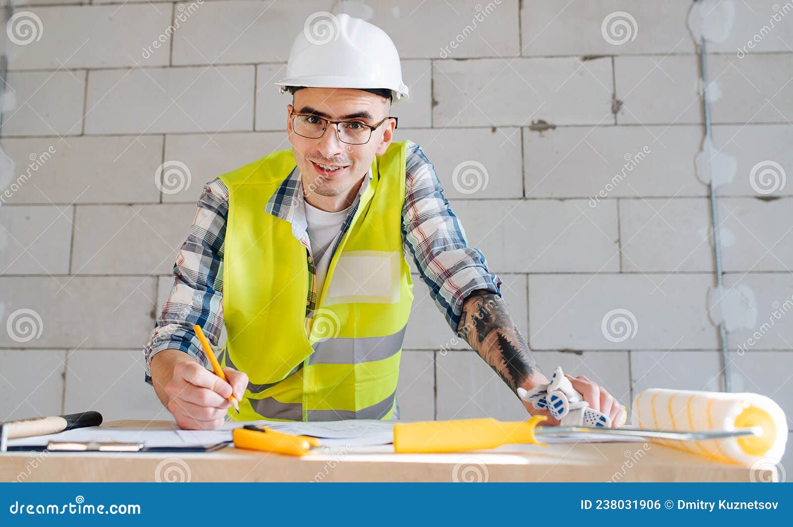 Friendly Construction Engineer Drawing on a Blueprint on an Improvised ...