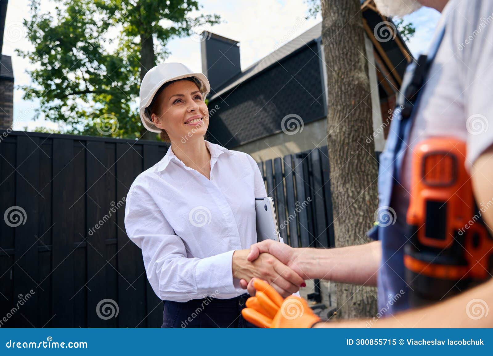 Friendly Construction Manager Greeting Builder with Handshake Outdoors ...