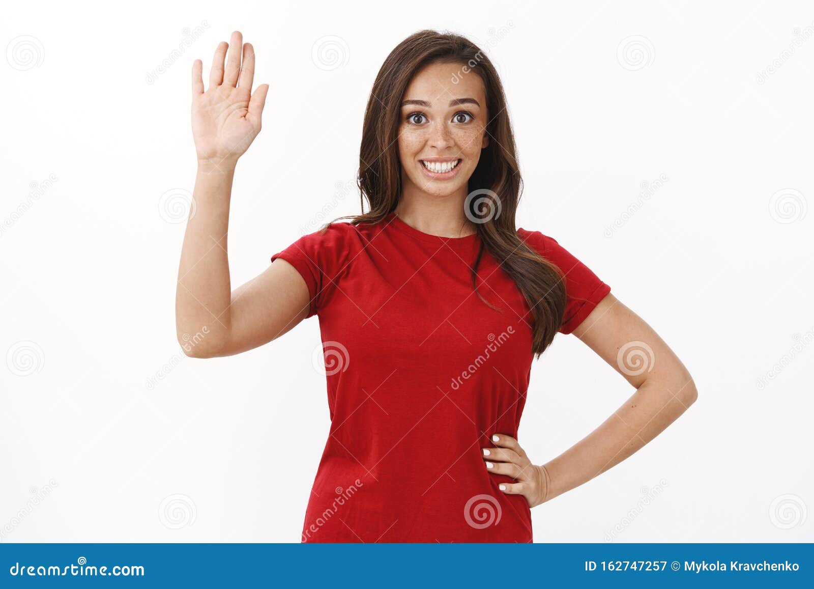 Friendly Cute Brunette Girl in Red T-shirt Raising Hand Up, Waving Palm ... Friendly Cute Brunette Girl in Red T-shirt Raising Hand Up, Waving Palm ...