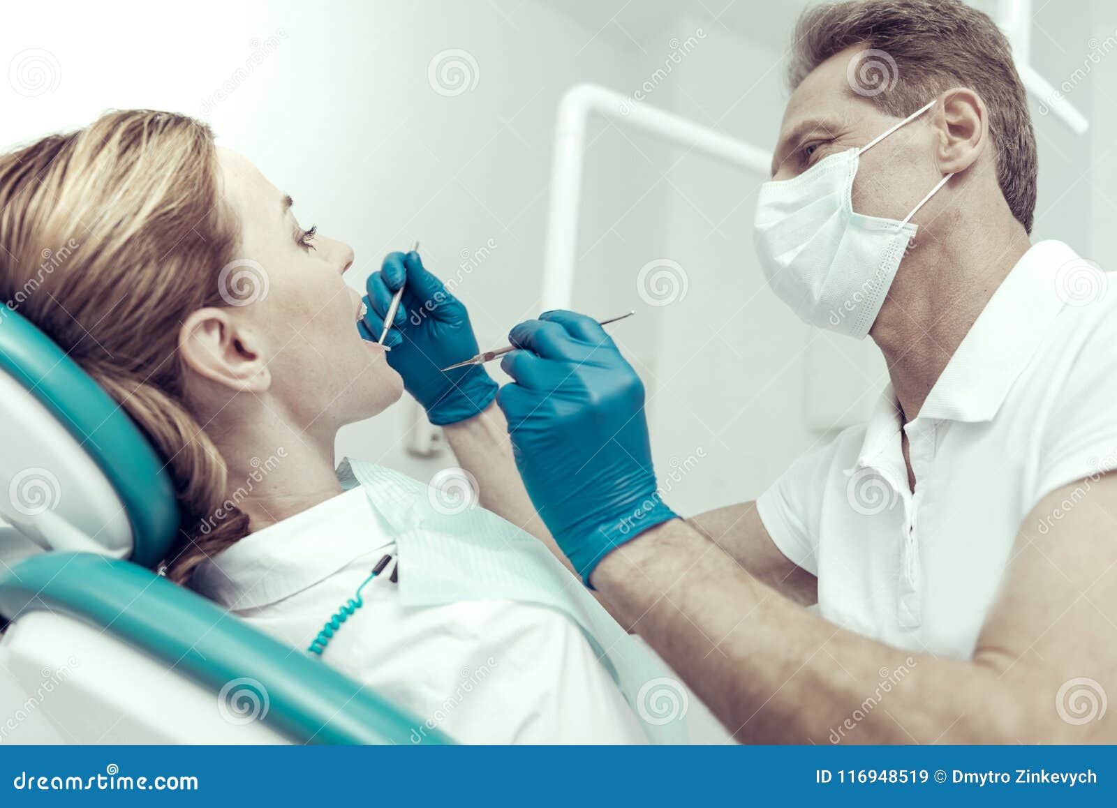 Friendly Dentist Checking the Front Teeth of His Patient Stock Image ...