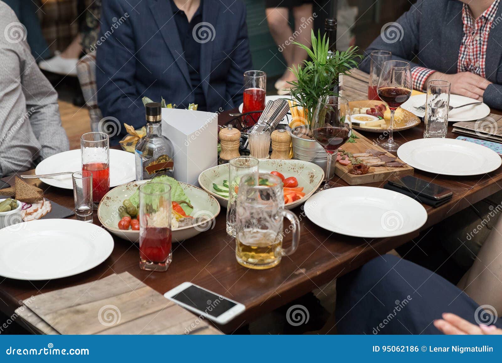 Friendly Dinner. Group of People Having Dinner Together while Sitting ...