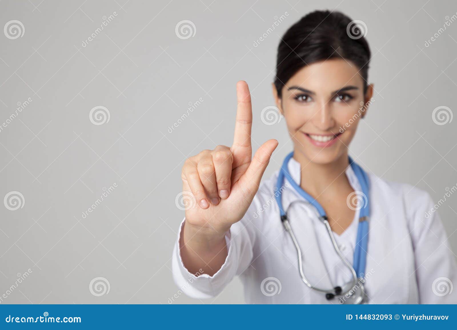 Friendly Smiling Doctor Pointing Her Finger on Copyspace Stock Image ...