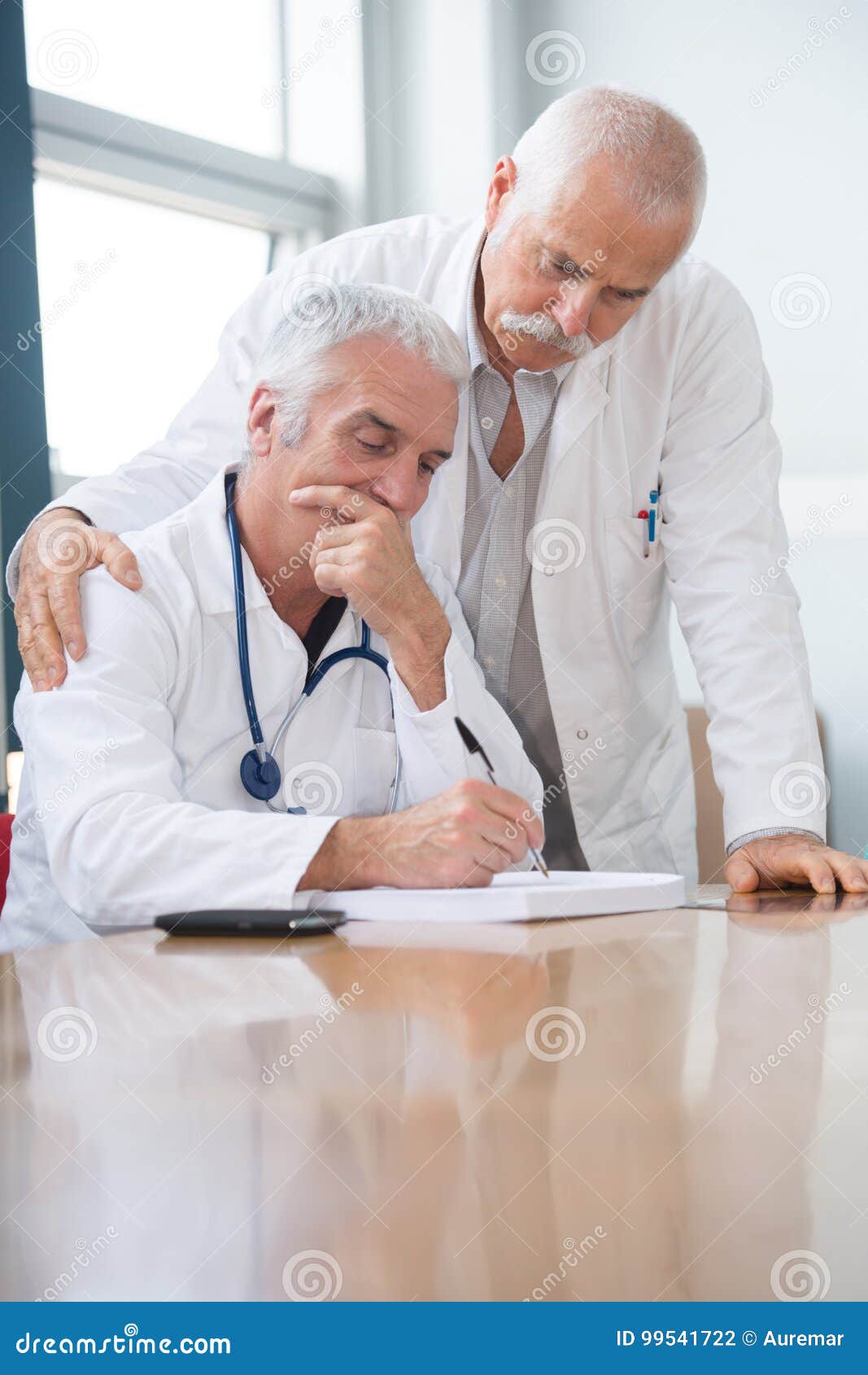 Friendly Doctors Checking Documents Stock Photo - Image of seniors ...