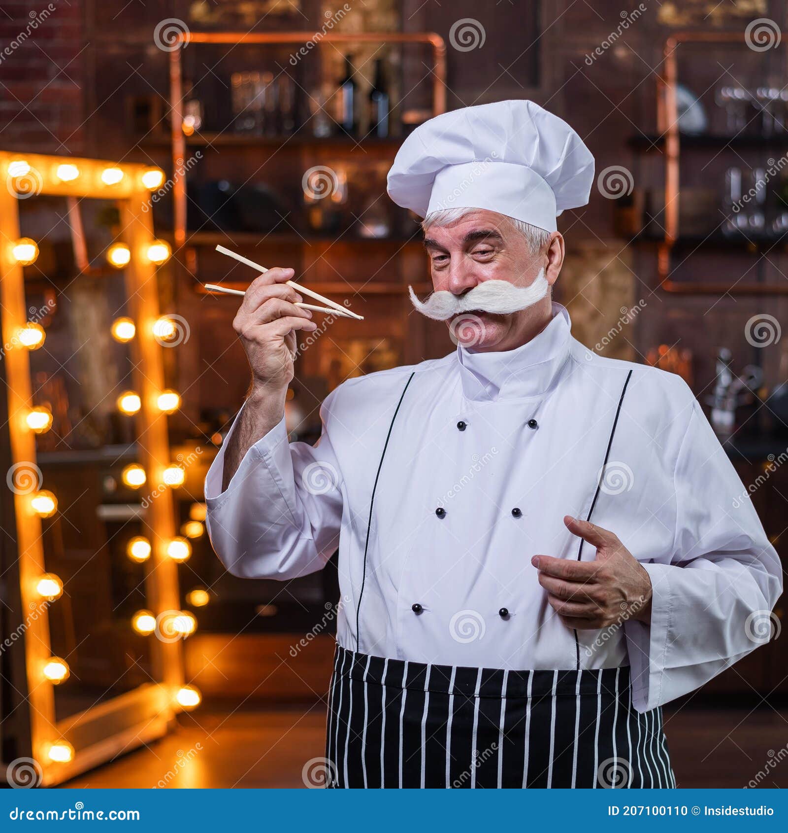 A Friendly Elderly Chef is Holding Chinese Sticks. a Gray-haired Man ...