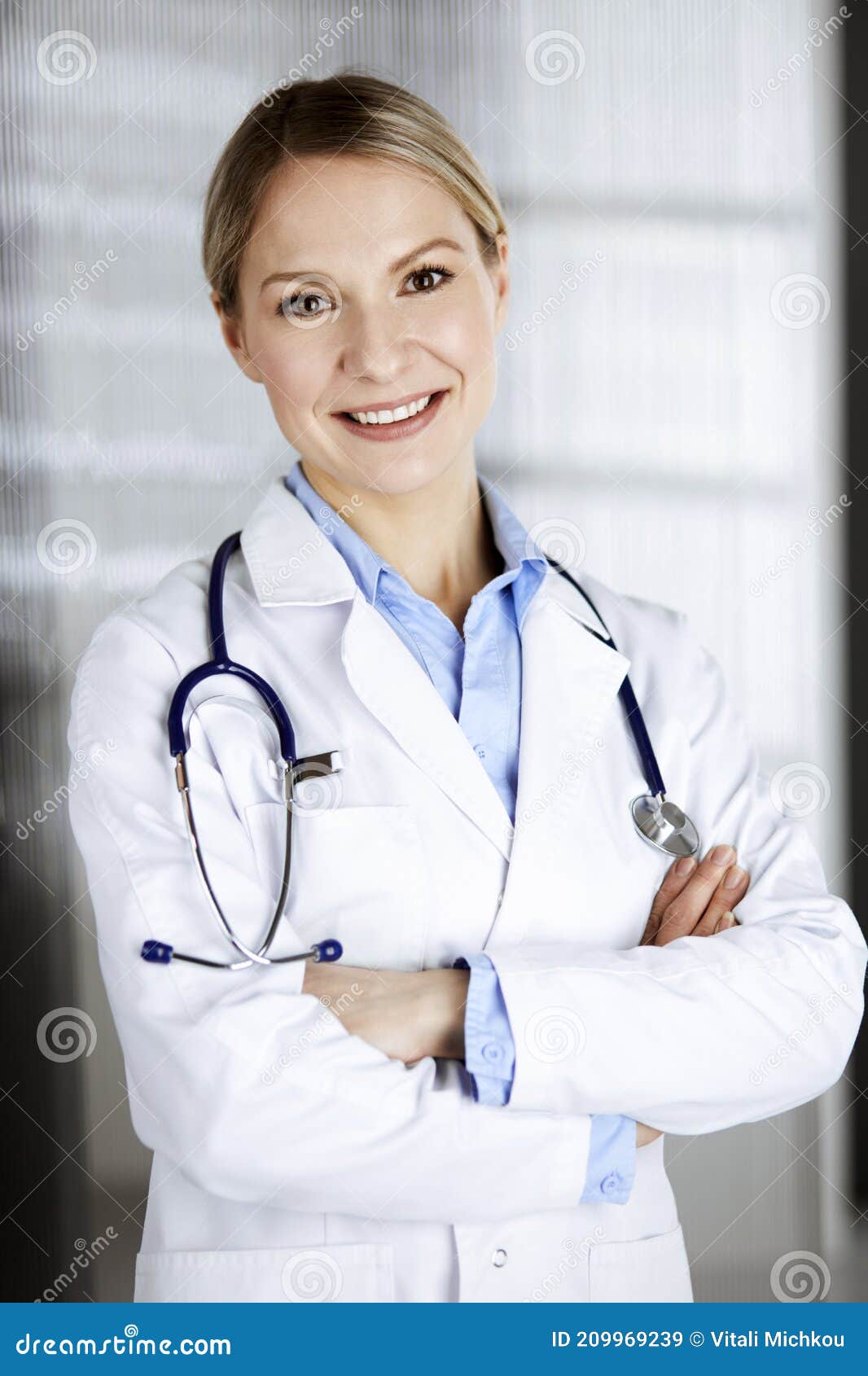 Friendly Female Doctor Standing In Clinic Portrait Of Cheerful Smiling