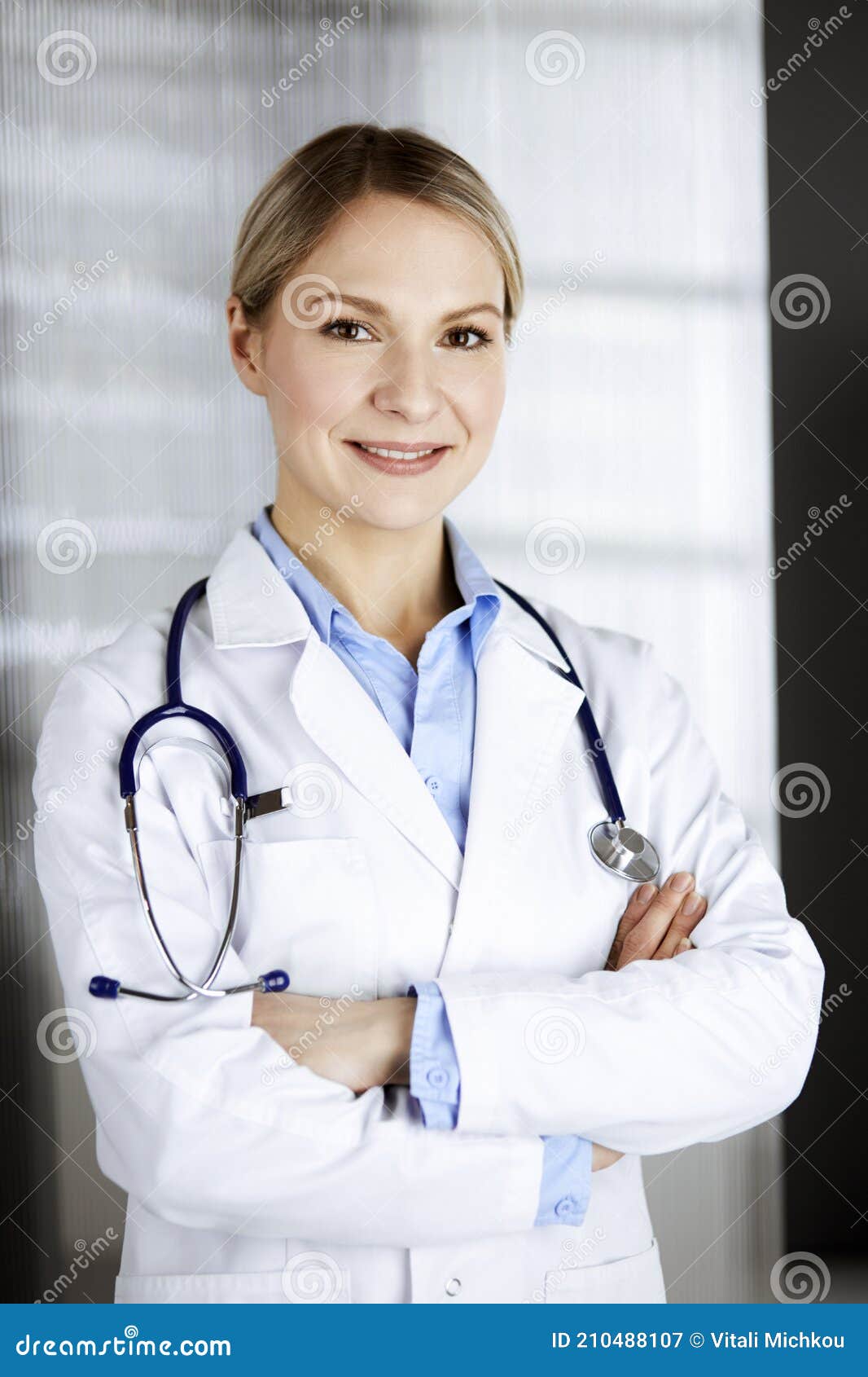 Friendly Female Doctor Standing In Clinic Portrait Of Cheerful Smiling
