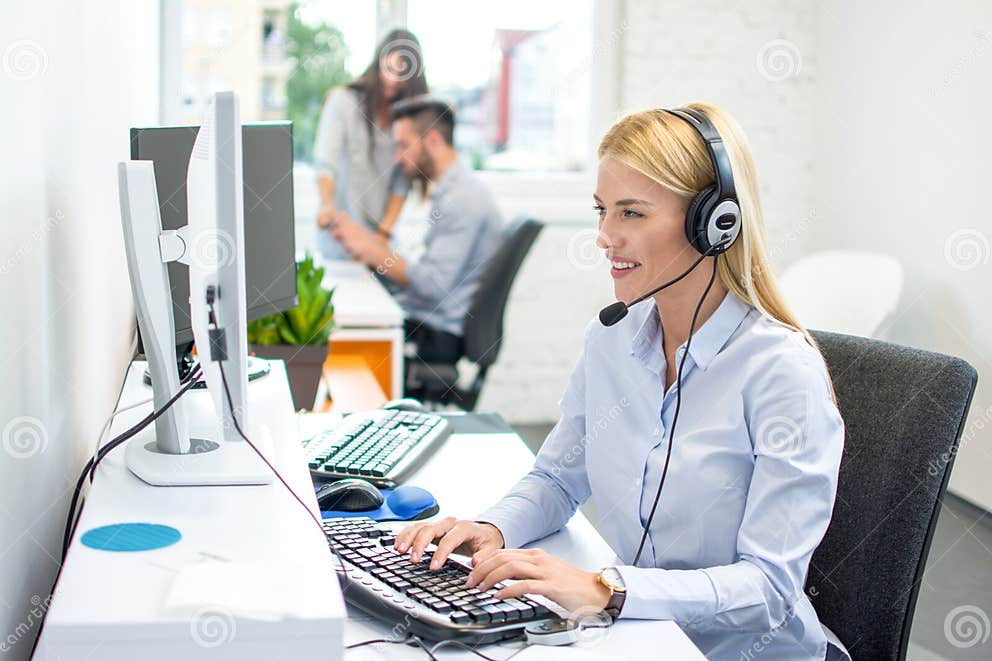 Friendly Female Helpline Operator Working on Computer at Office. Stock ...