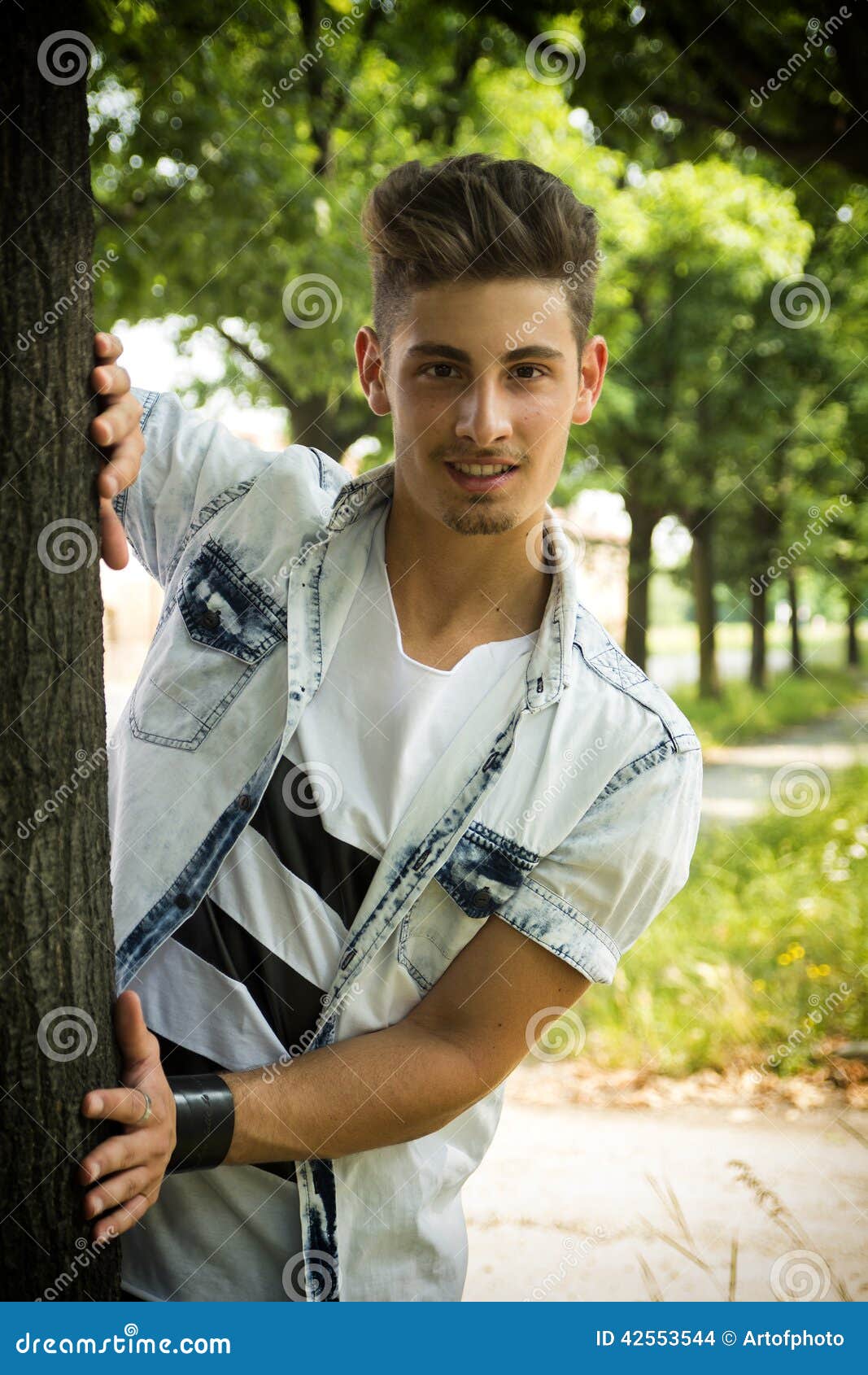 Friendly Handsome Young Man Behind Tree Smiling Stock Photo - Image of ...