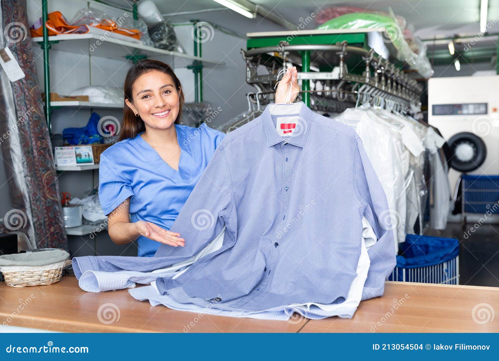Laundry Worker Demonstrates Clean Clothes Stock Photo - Image of ...