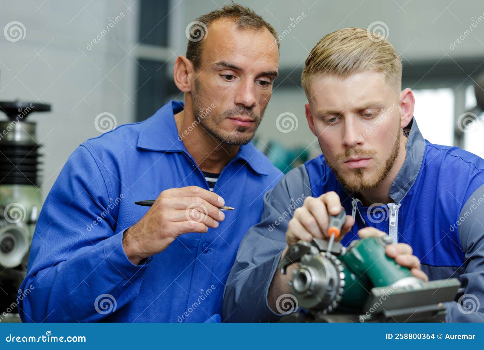 Friendly Master Electrician and Apprentice Working on Breaker Panel ...