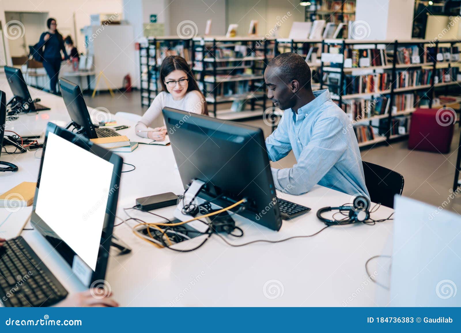 Friendly Multiracial Students Doing Homework Together and Using ...