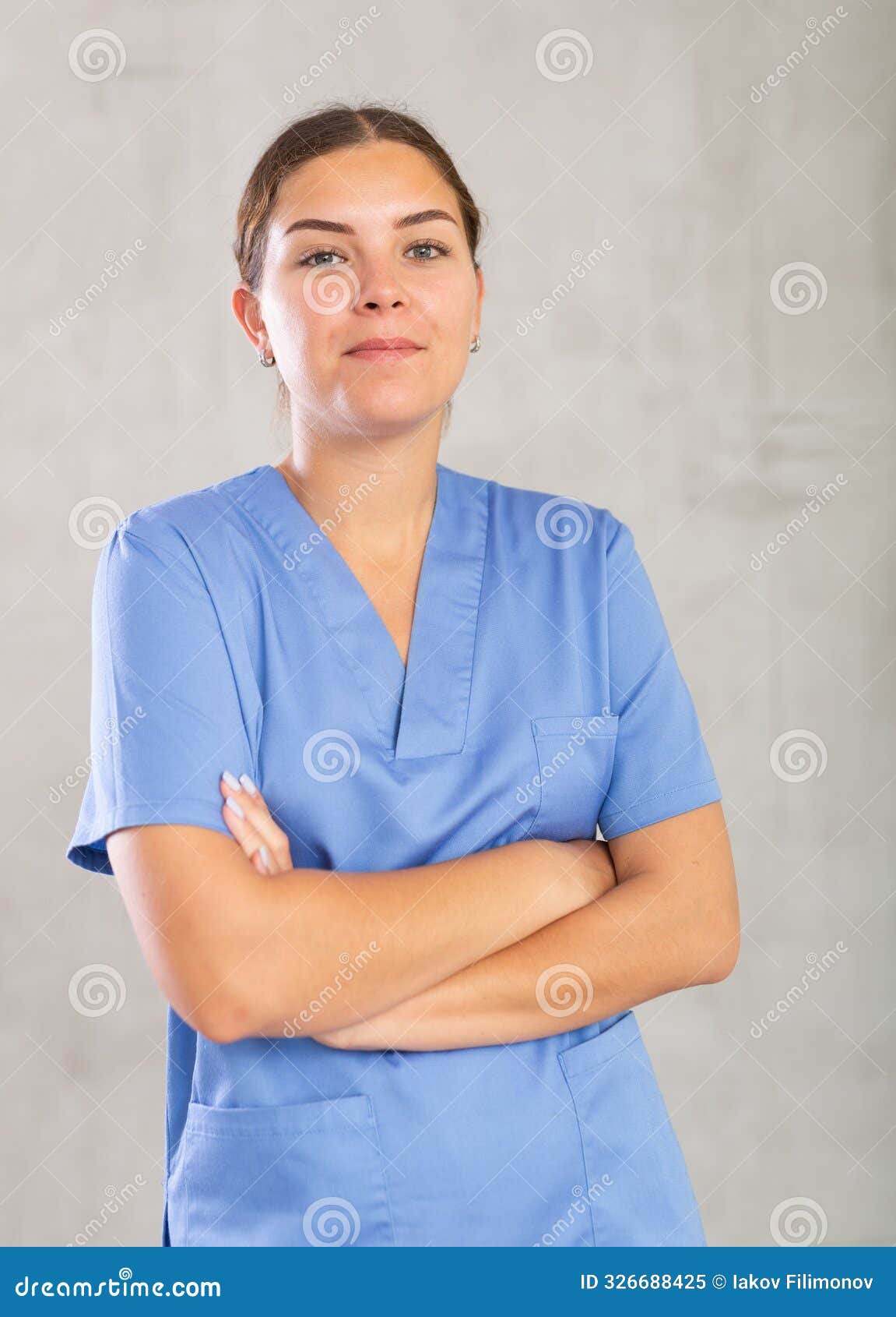 Friendly Nurse in Blue Coat Posing Against Gray Studio Background ...