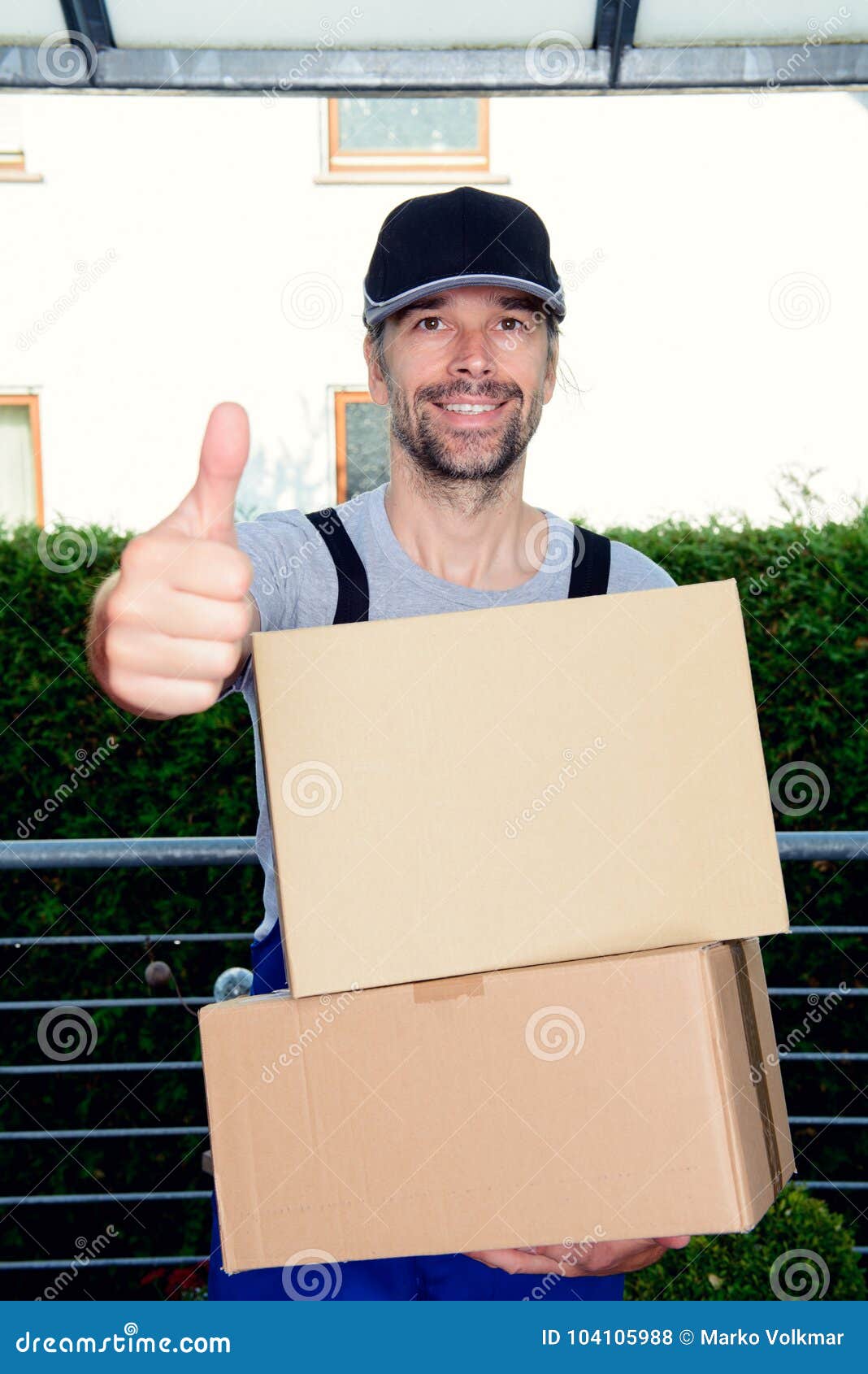 Friendly Postman with Parcels and Thumb Up Stock Photo - Image of adult ...