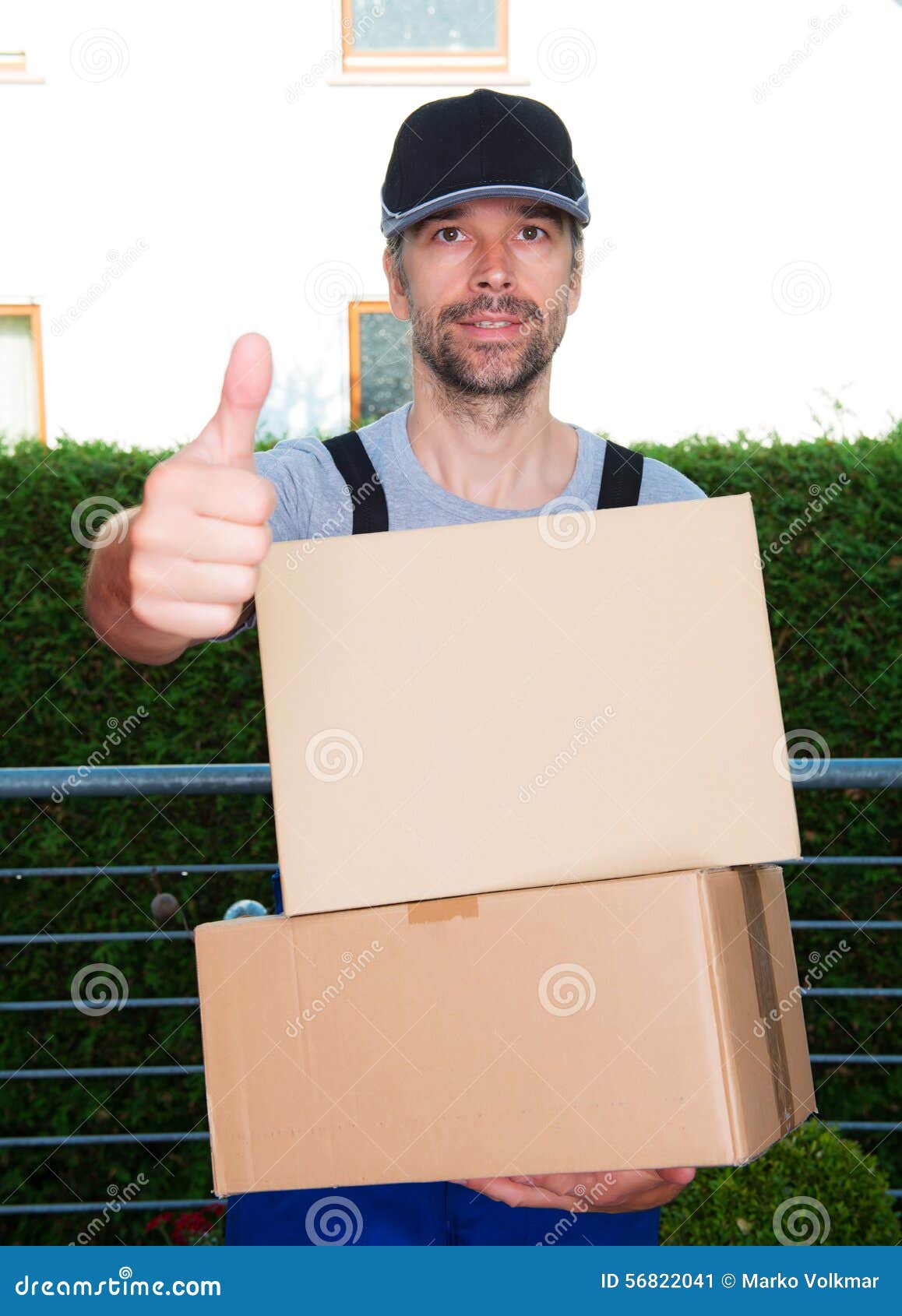 Friendly Postman with Parcels and Thumb Up Stock Image - Image of ...