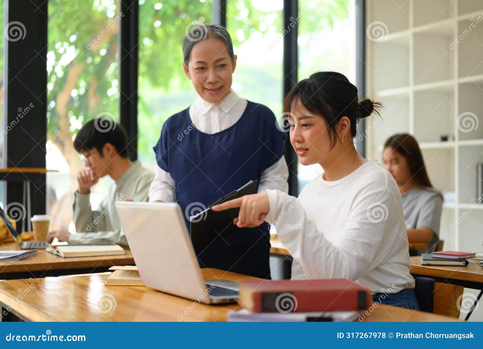Friendly Senior Professor Helping Female Student with Assignment Stock ...