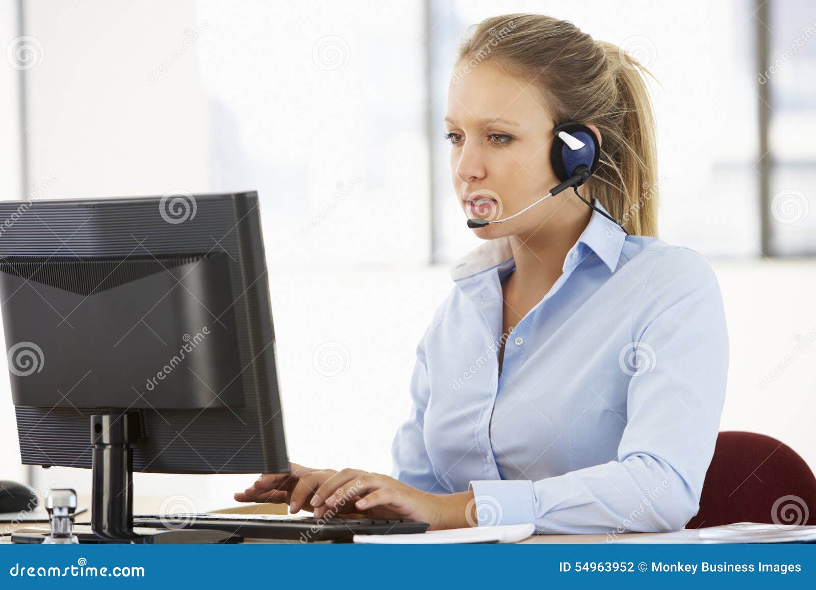 Friendly Service Agent Talking To Customer in Call Centre Stock Photo ...