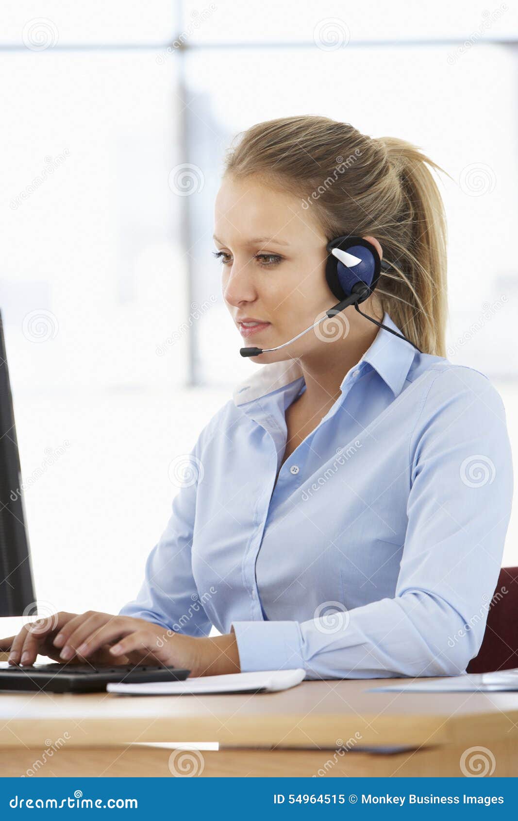 Friendly Service Agent Talking To Customer in Call Centre Stock Image ...